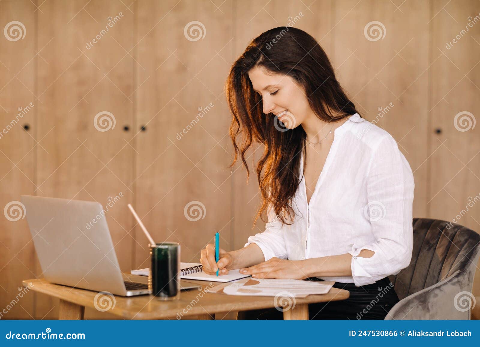 The Girl is Sitting at a Desk in the Office and Working Stock Photo ...
