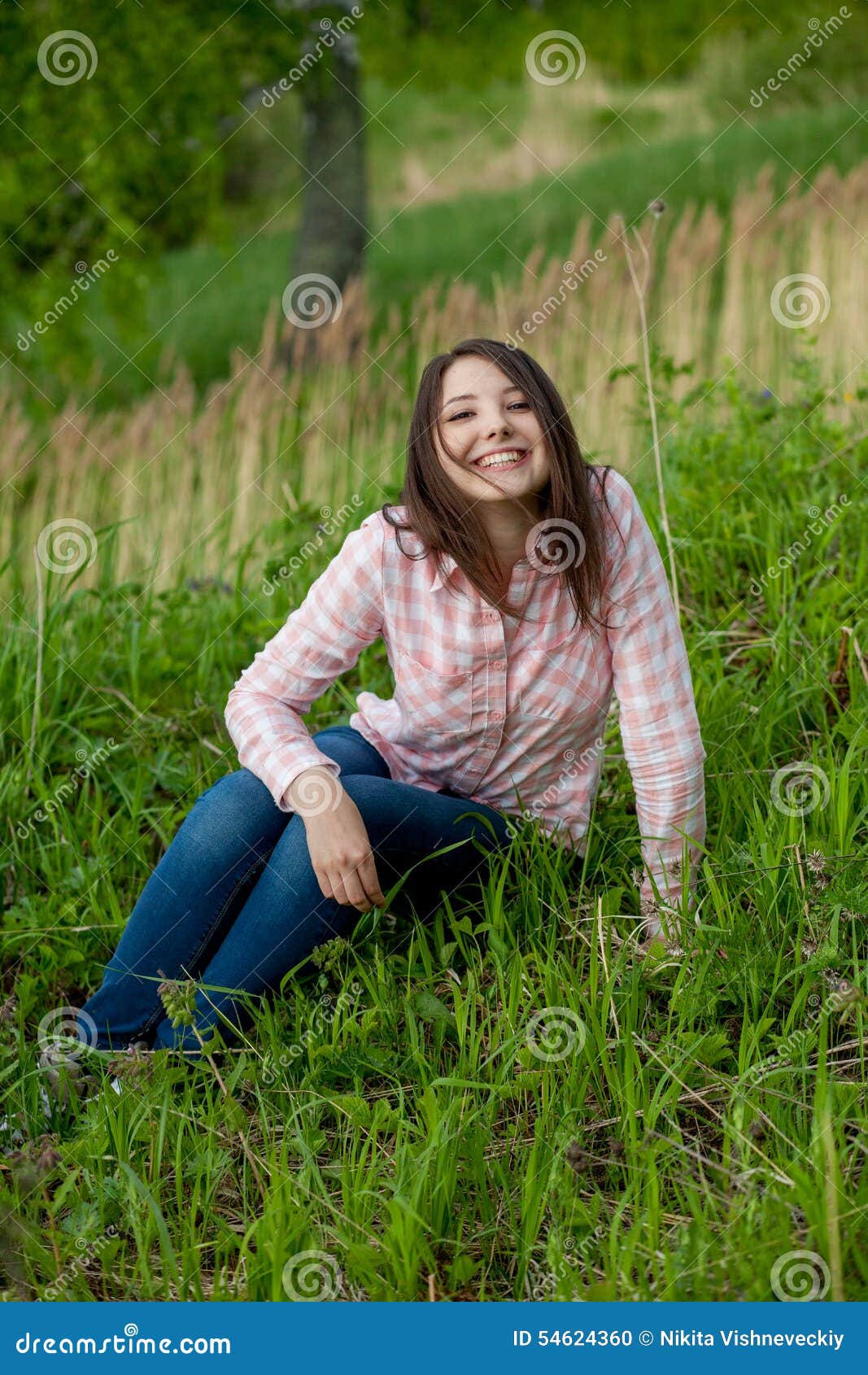 Girl sitting on the field stock photo. Image of shirt - 54624360