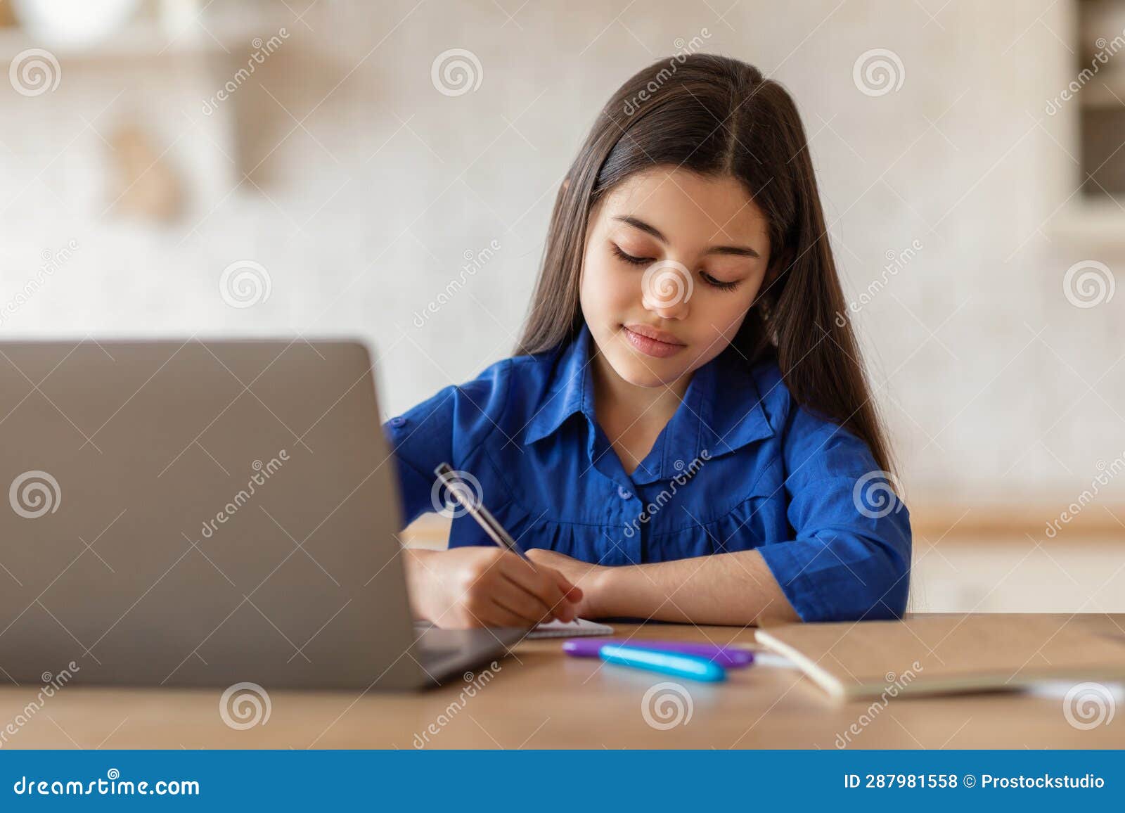 Girl Sitting in Front of Computer Taking Notes at Home Stock Photo ...