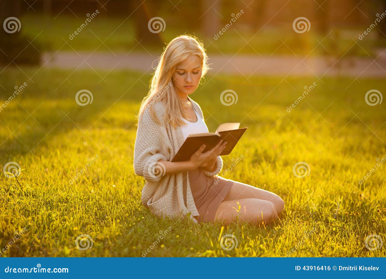 Girl Sitting on the Grass and Reading a Book Stock Photo - Image of ...