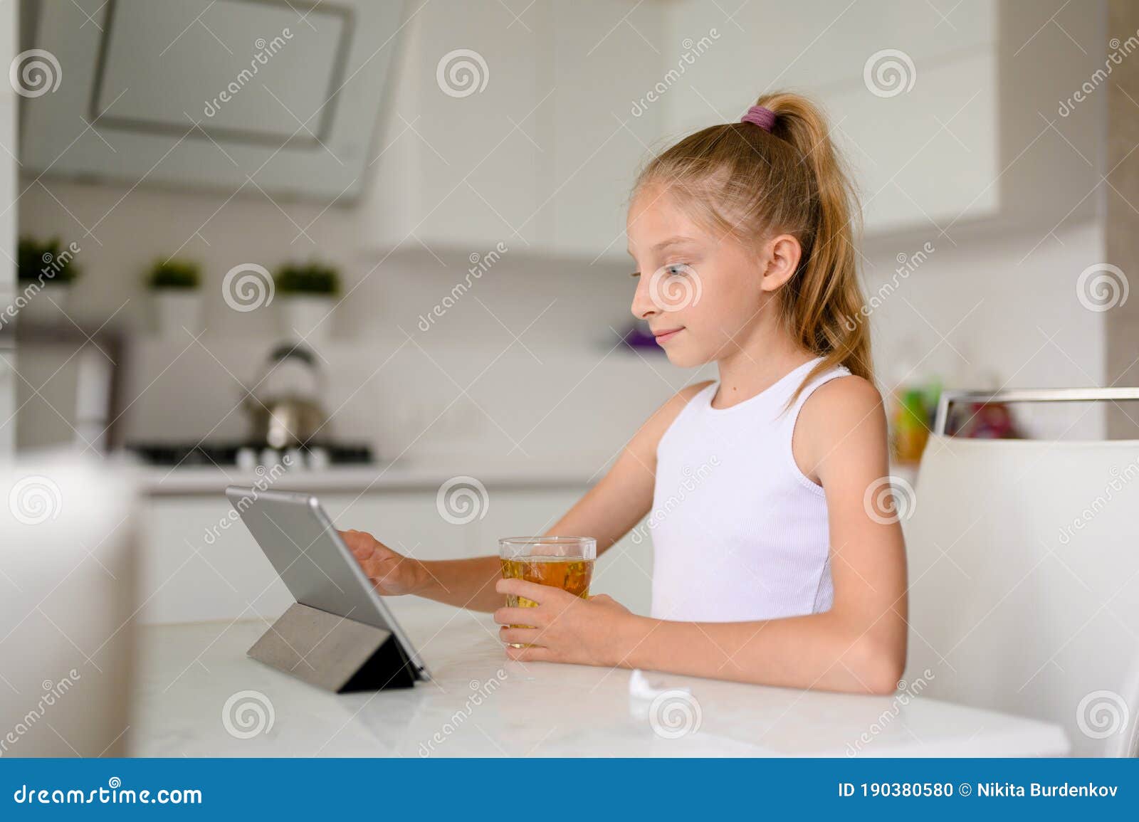 Girl Sitting in the Kitchen at the Table after Breakfast. Stock Photo ...