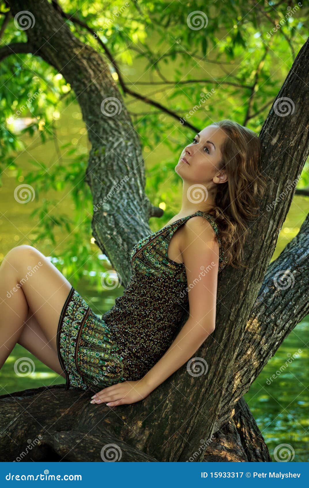 Girl sitting on large tree stock image. Image of serious - 15933317