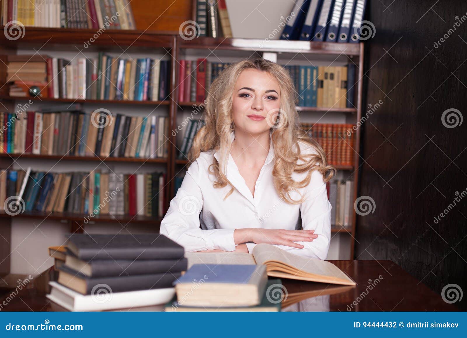 The Girl Sitting in the Library Reading Books is Preparing for the Exam ...