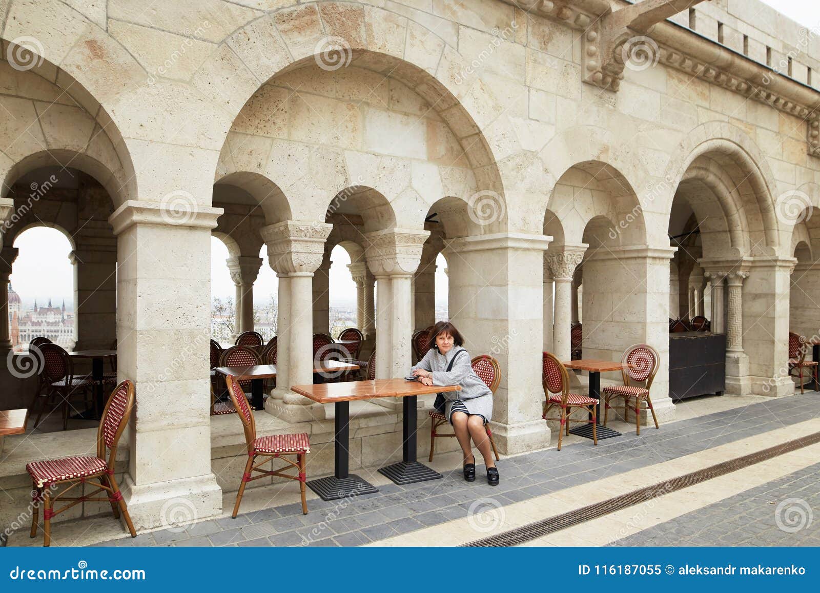 The Girl is Sitting on a Parapet with Columns. Stock Image - Image of ...