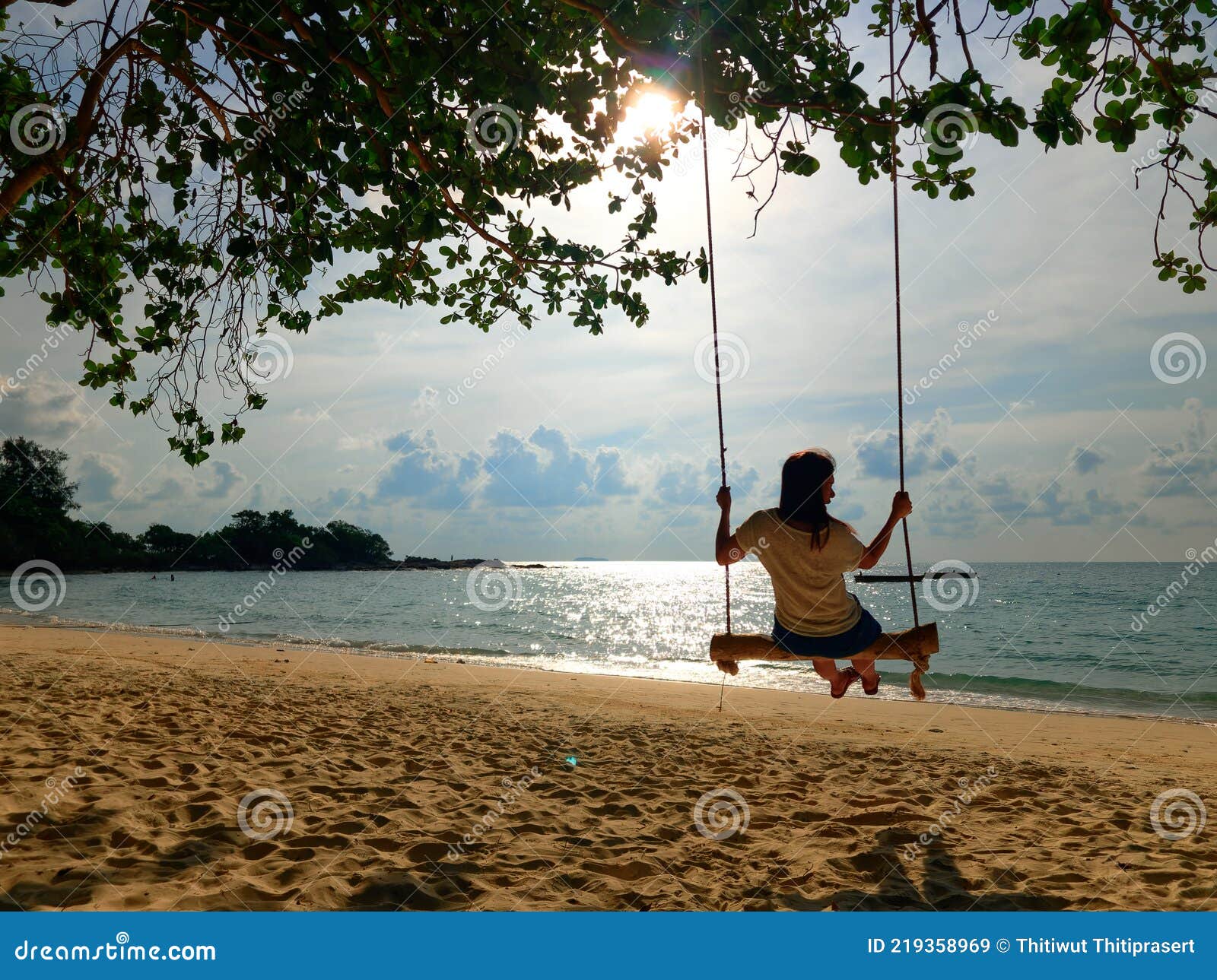 A Girl Sitting On Swing On A Sandy Beach Vacation Freedom Stock Image