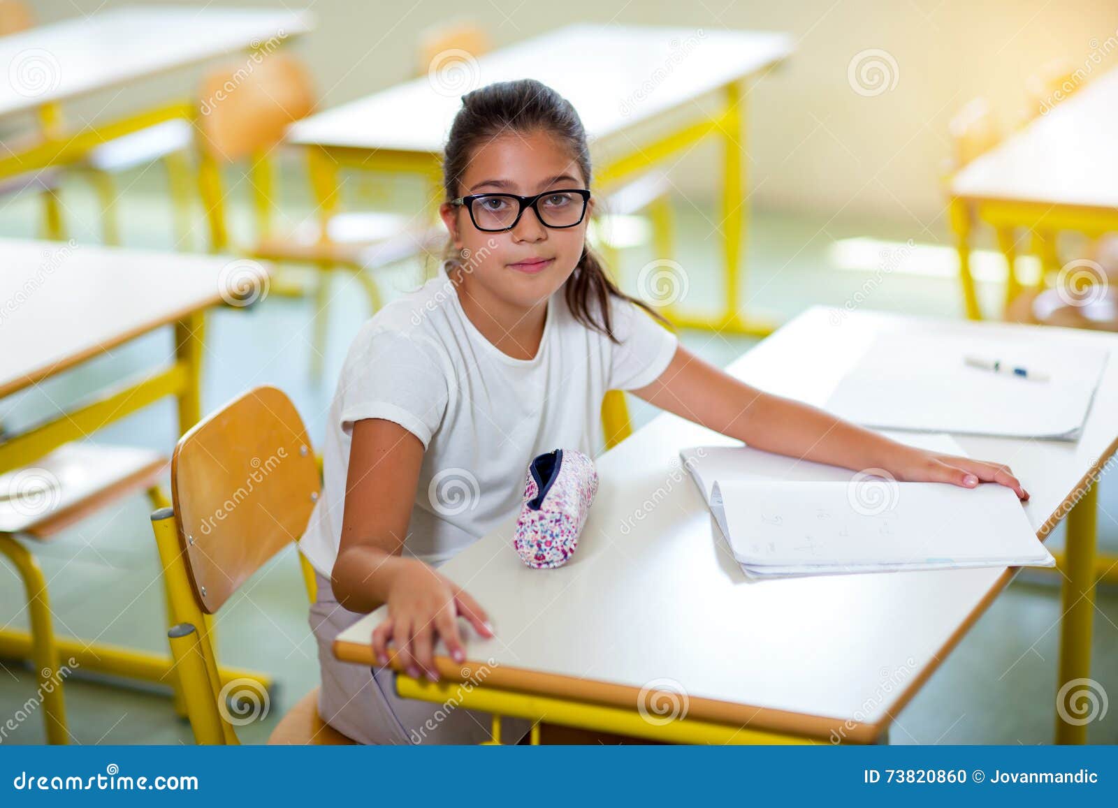 Girl Sitting at a Table in the Classroom Stock Photo - Image of ...