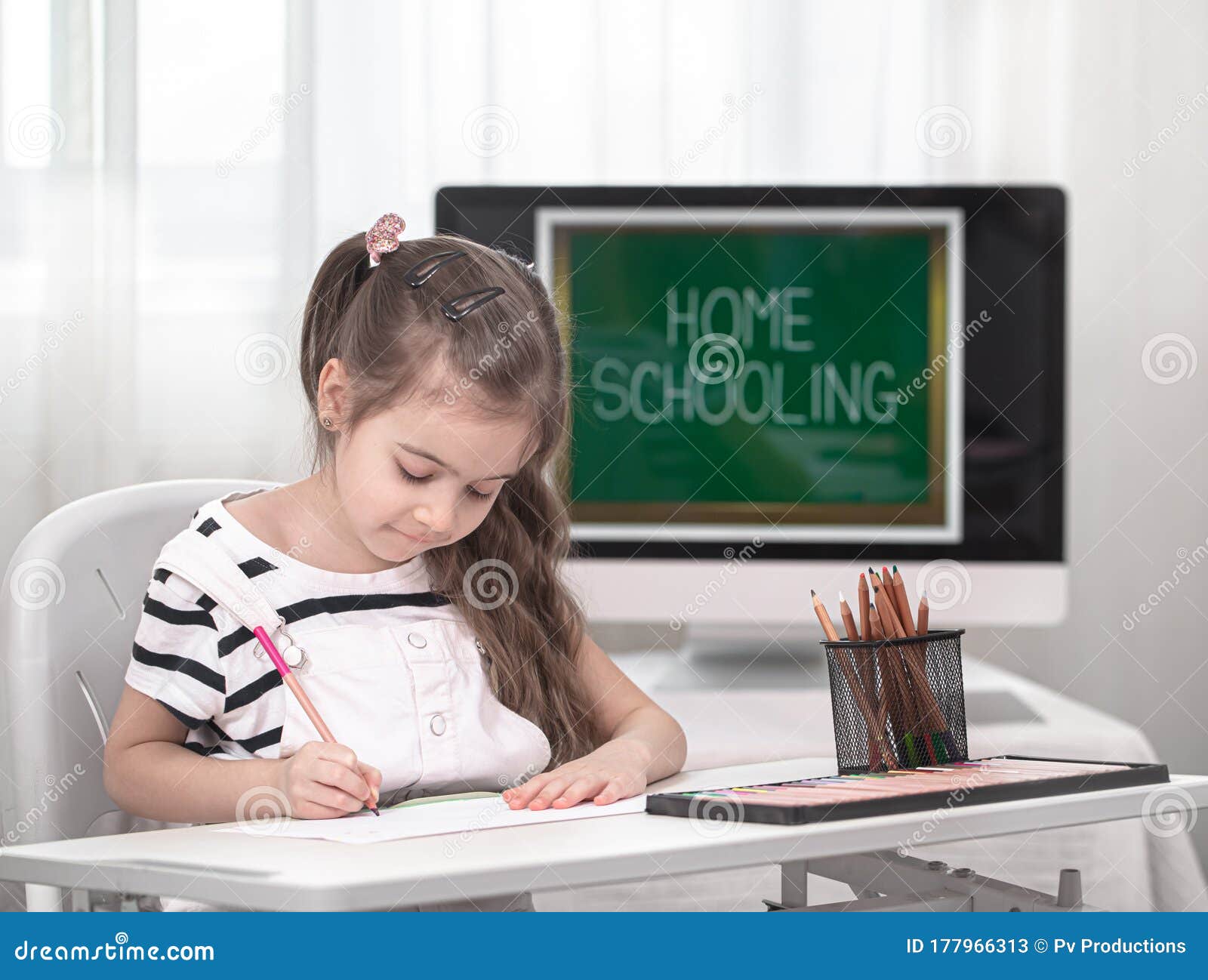The Girl is Sitting at the Table and Doing Homework. the Child Learns ...