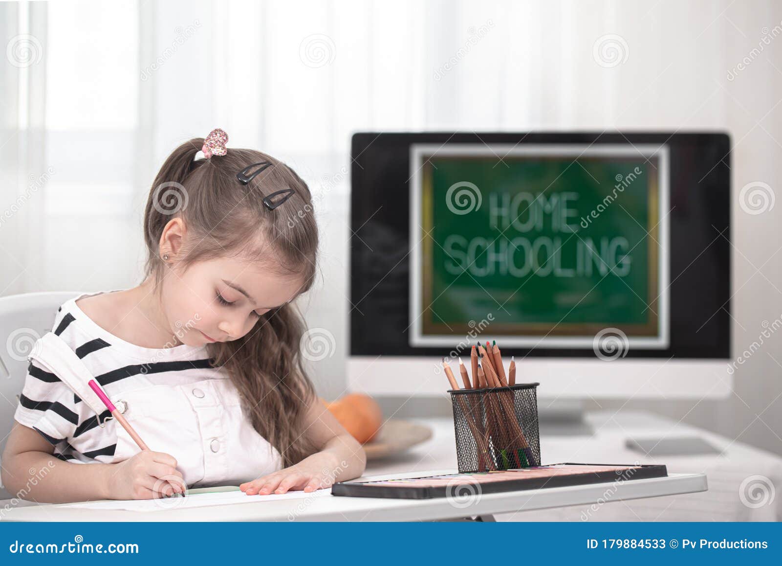 The Girl is Sitting at the Table and Doing Homework. the Child Learns ...