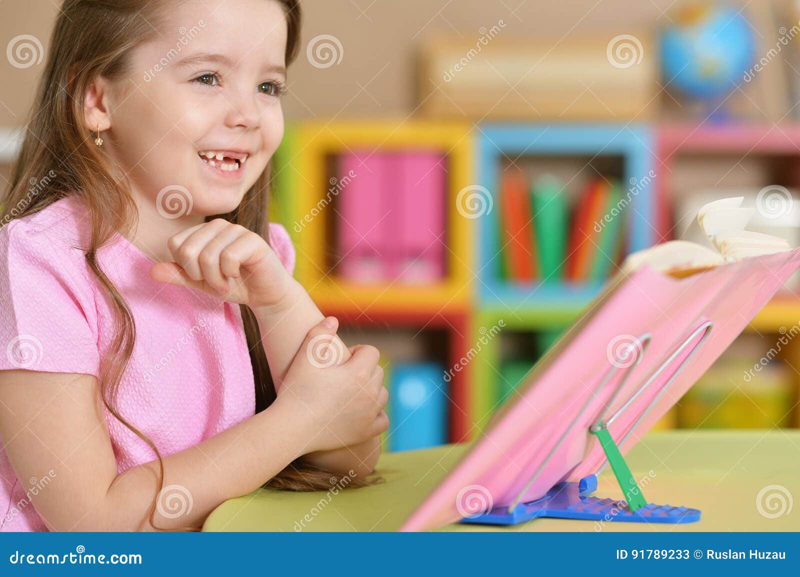 Girl is Sitting at the Table and Reading a Book Stock Image - Image of ...