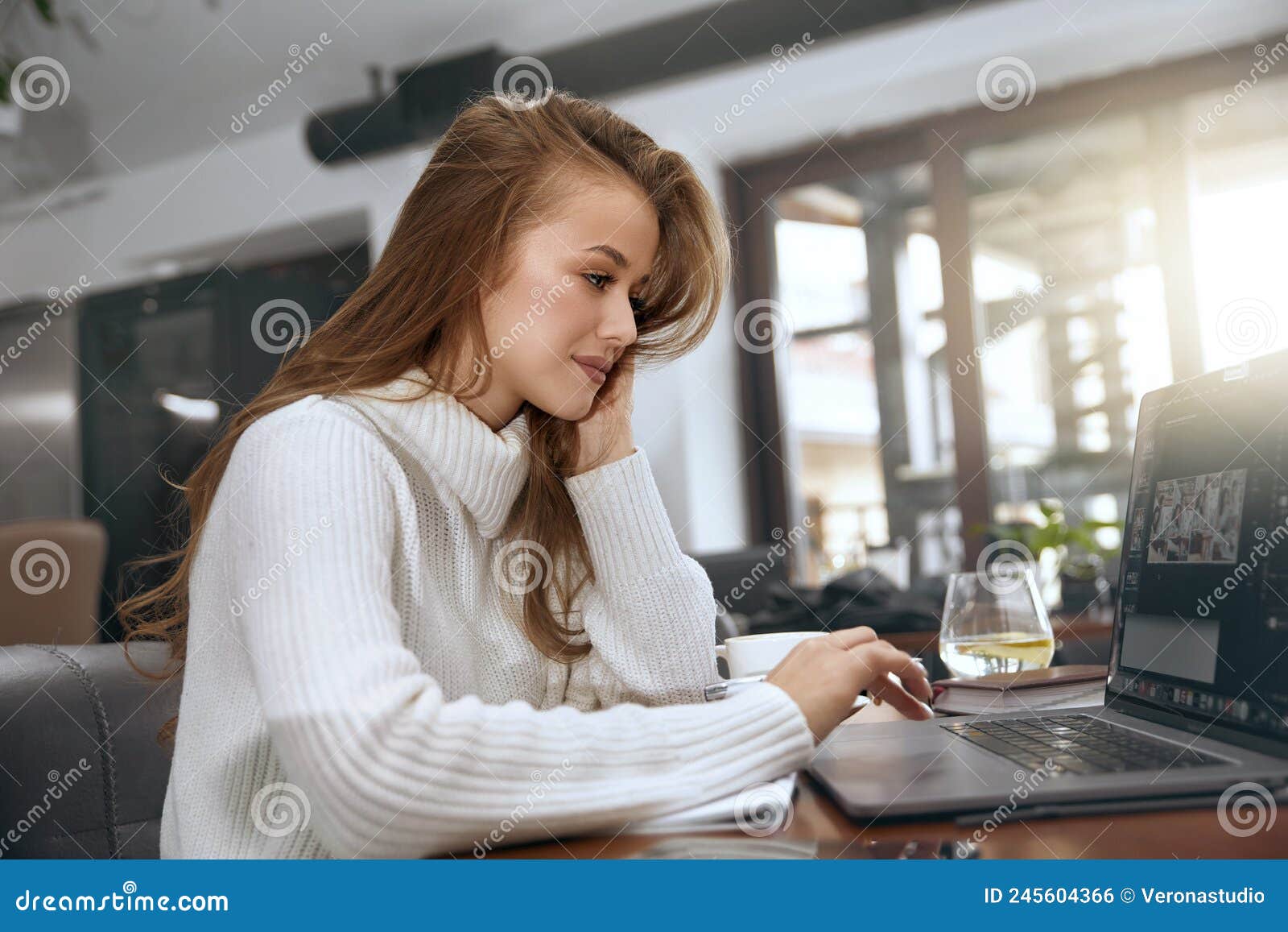 Girl Sitting at the Table and Using Laptop Computer. Stock Photo ...