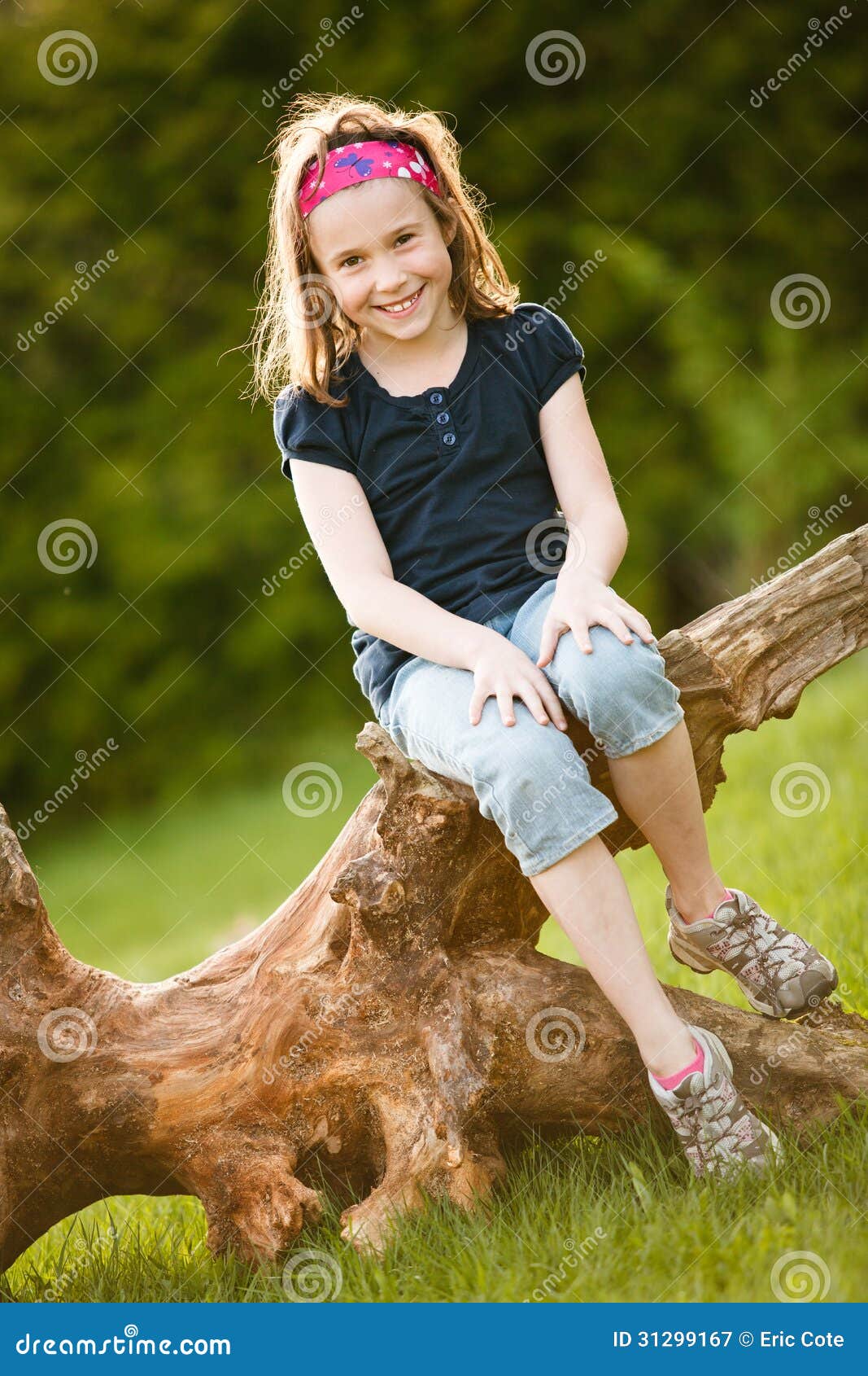 Girl Sitting on a Tree Trunk Stock Image - Image of girl, happy: 31299167
