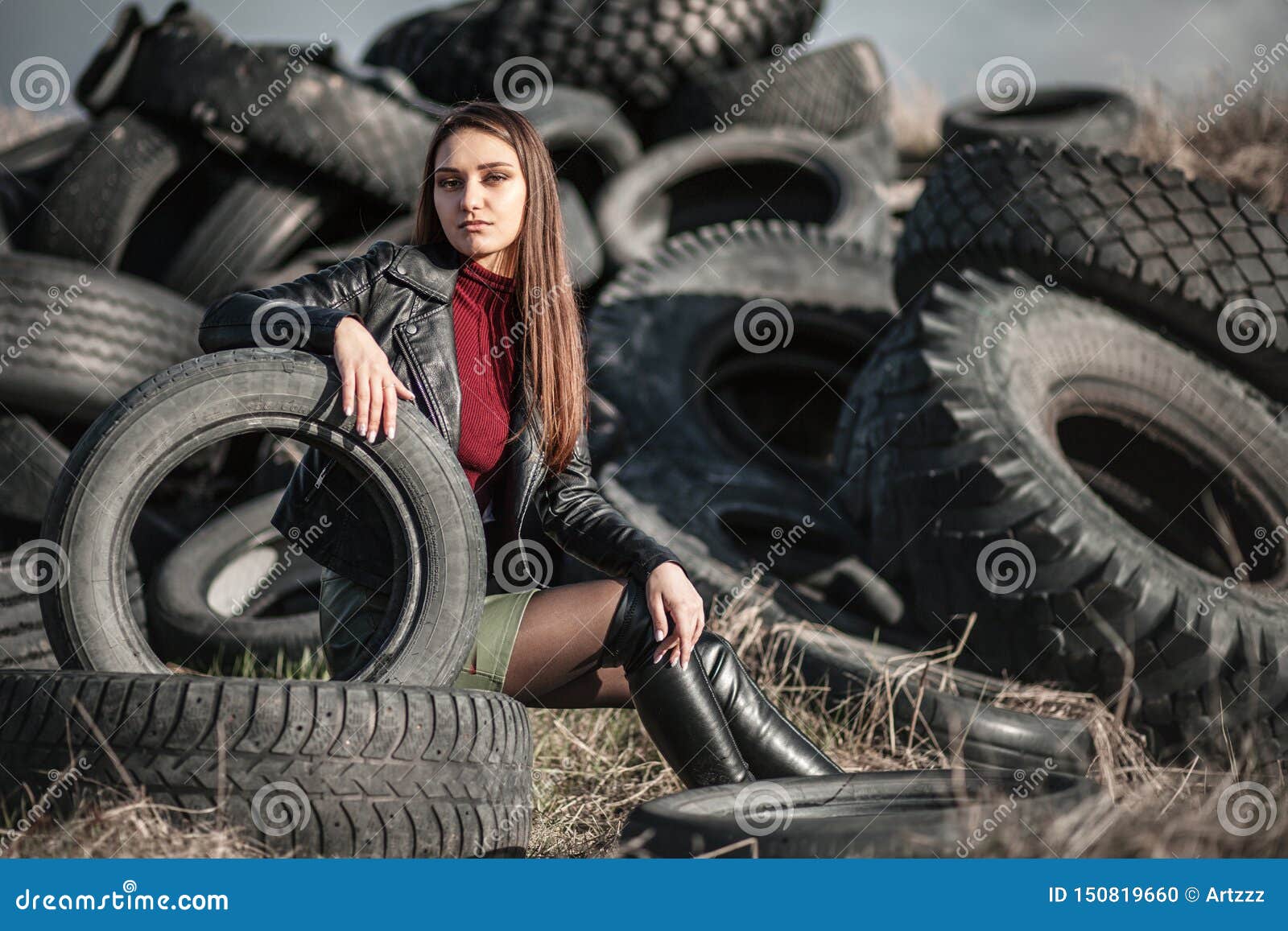 Girl sitting in the tyres stock photo. Image of industry - 150819660