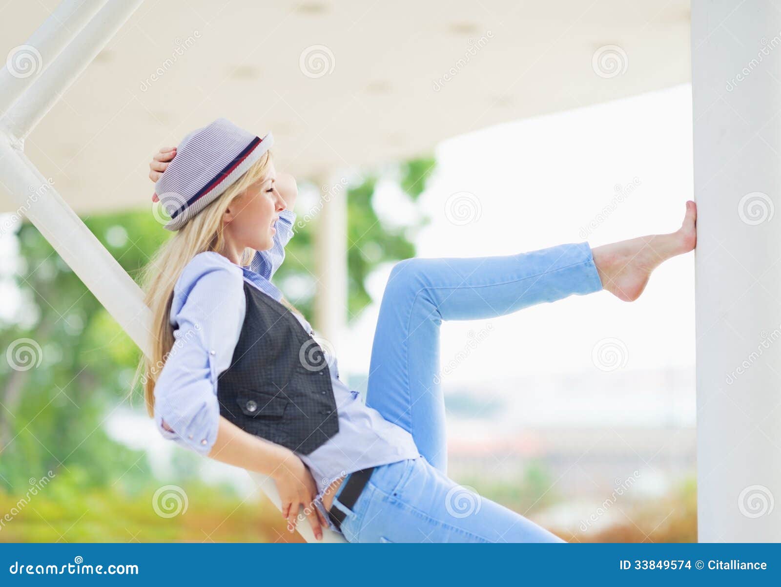 Girl Sitting on Urban Structure and Looking into Distance Stock Photo ...
