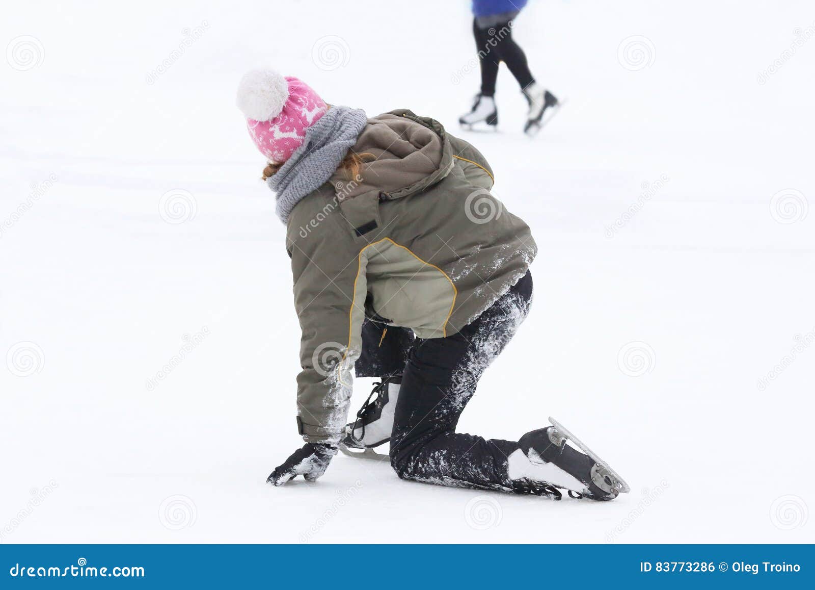 Girl on the Skates Rises after a Fall on the Ice Rink Stock Photo ...