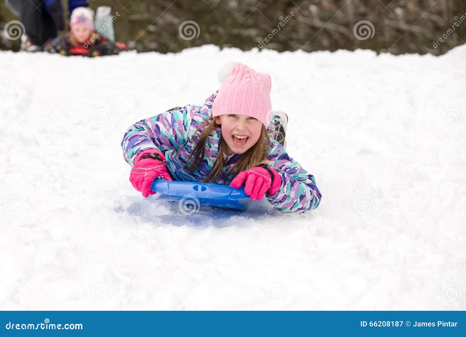 Girl Sledding Head First and Looking at Camera Stock Image - Image of ...