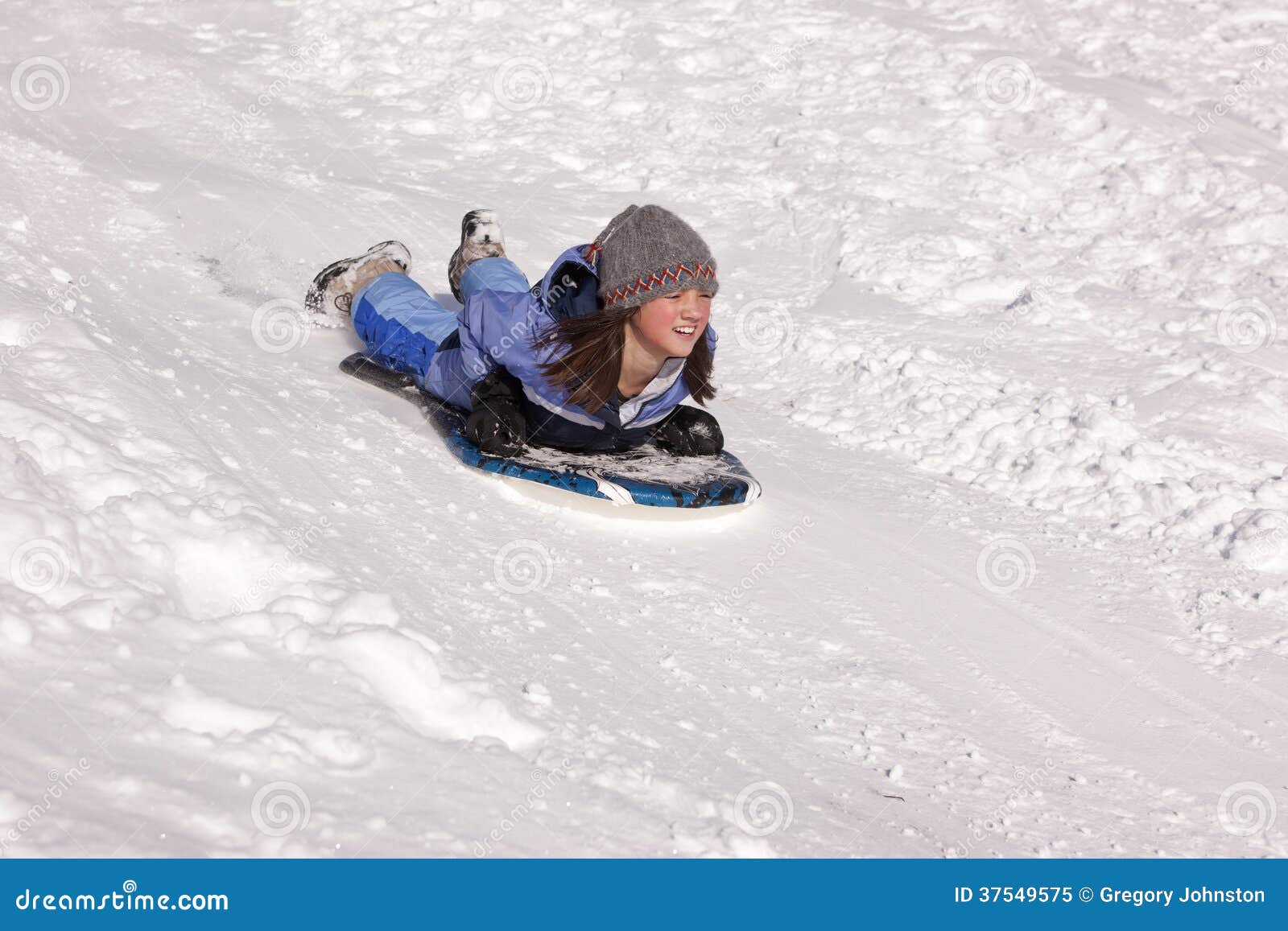 Girl sleds down hill. stock image. Image of activity - 37549575