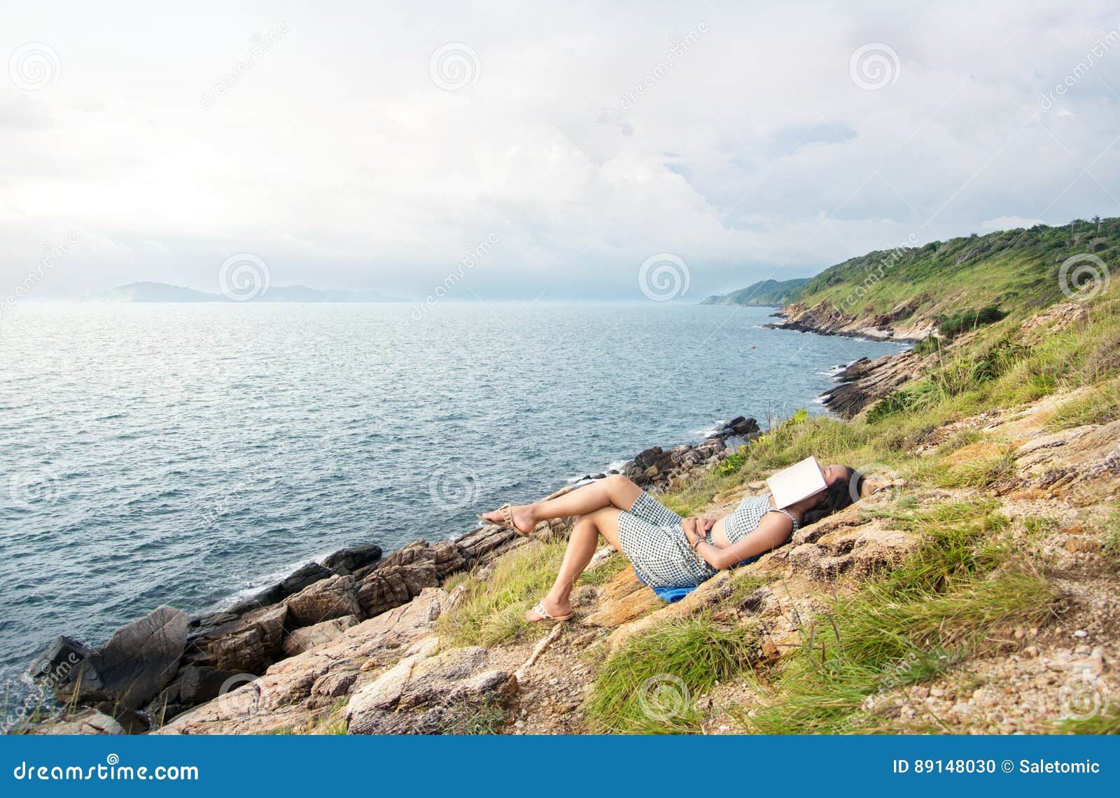 Girl Sleeping with a Book on Cliff Stock Photo - Image of beach, beauty ...