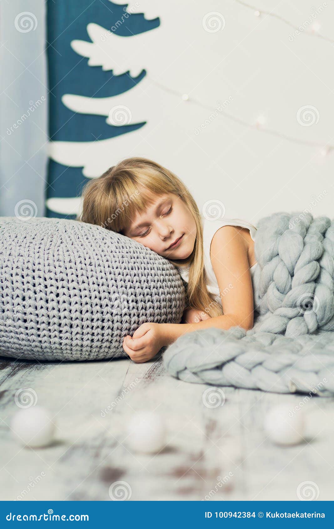 The Girl is Sleeping on a Pillow Under a Rug on the Background of a ...