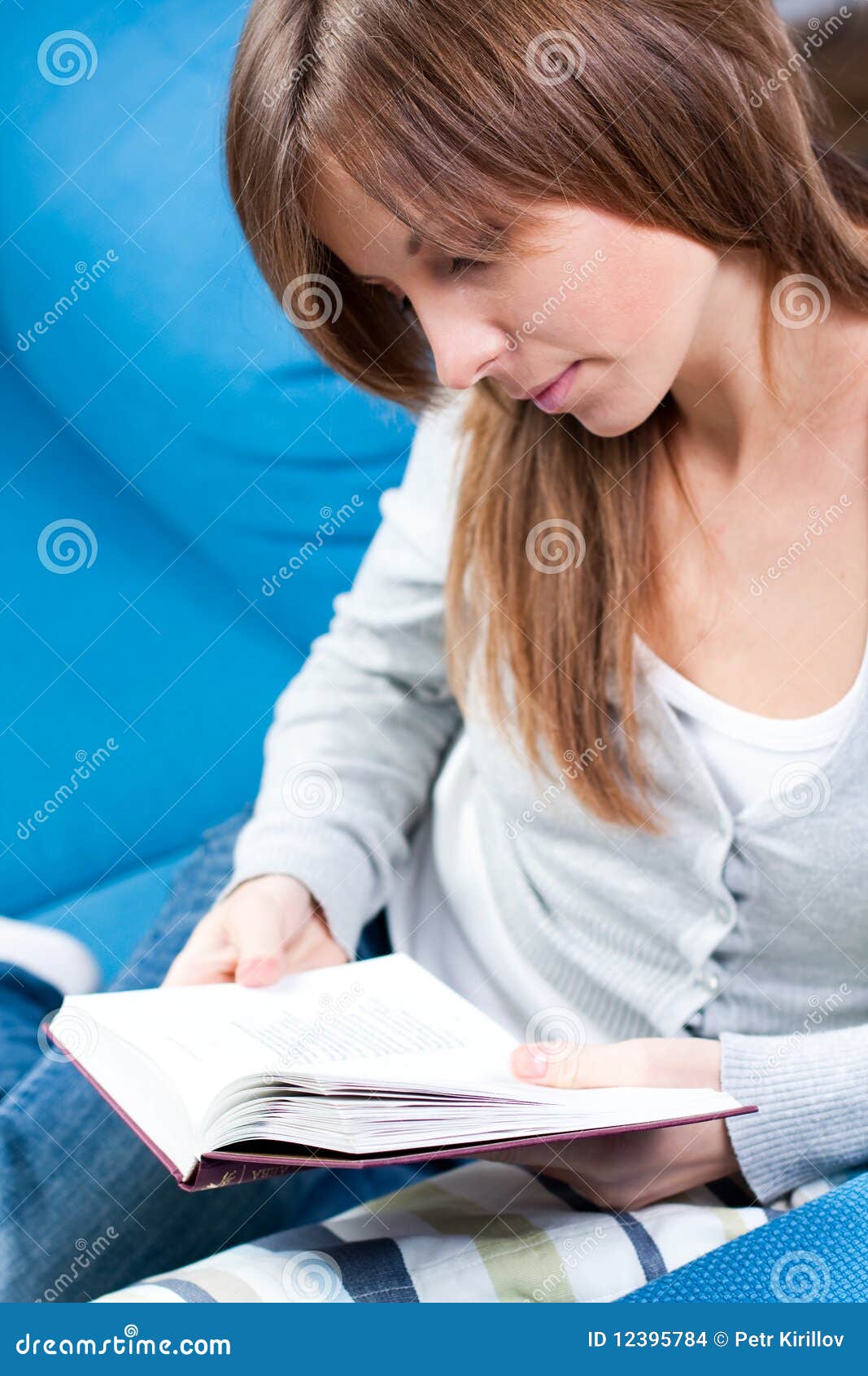 Girl of sofa reading book stock photo. Image of people - 12395784