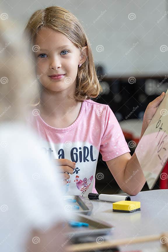 A Girl is Solving a Math Problem on a White Board Stock Image - Image ...