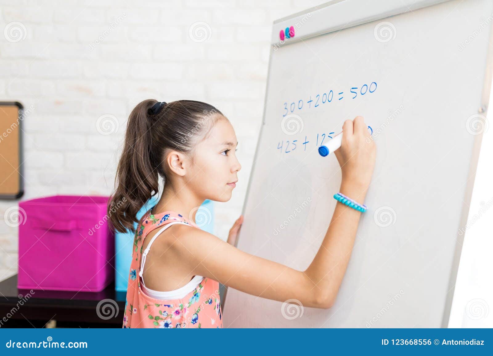 Girl Solving Math`s Sums on Flip Chart at Home Stock Photo - Image of ...