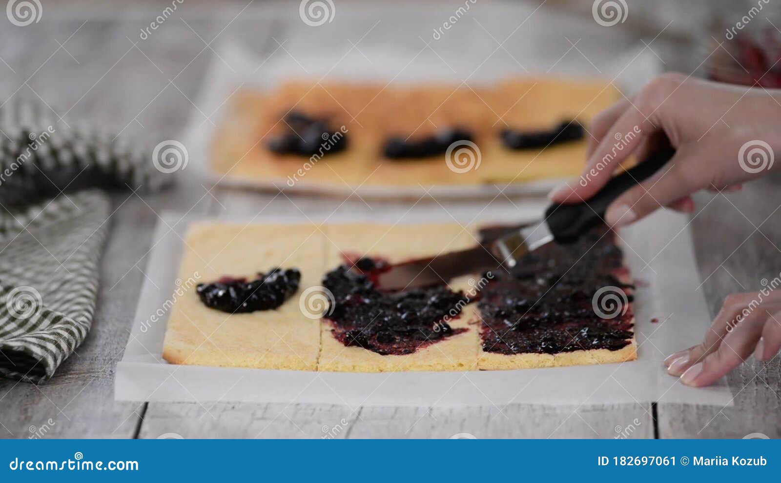 Girl Spreading Jam on a Flat Sheet of Cake To Make a Cake with Vertical ...