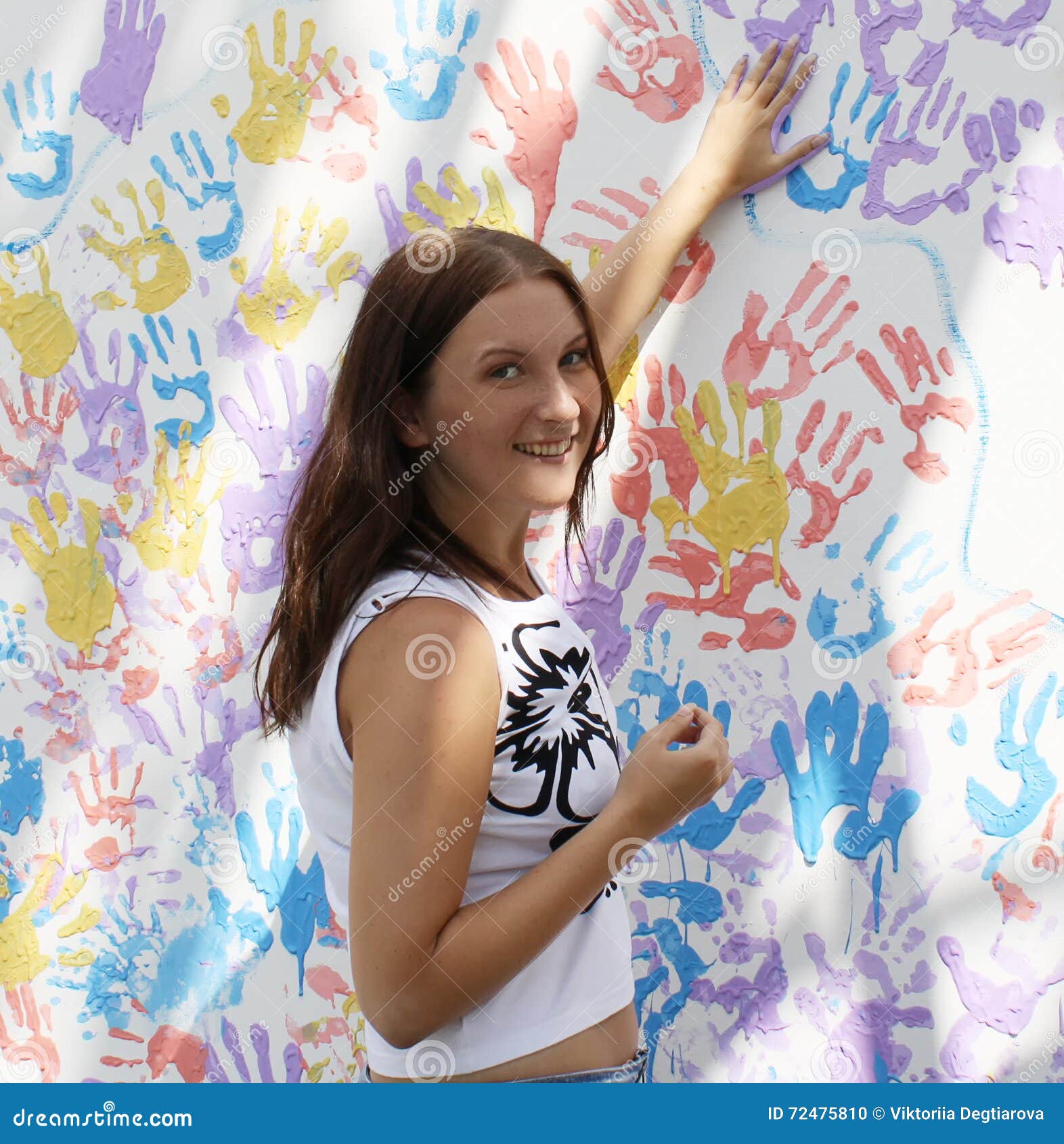 Girl Stamps Trace Hands on Wall with Prints Stock Photo - Image of ...
