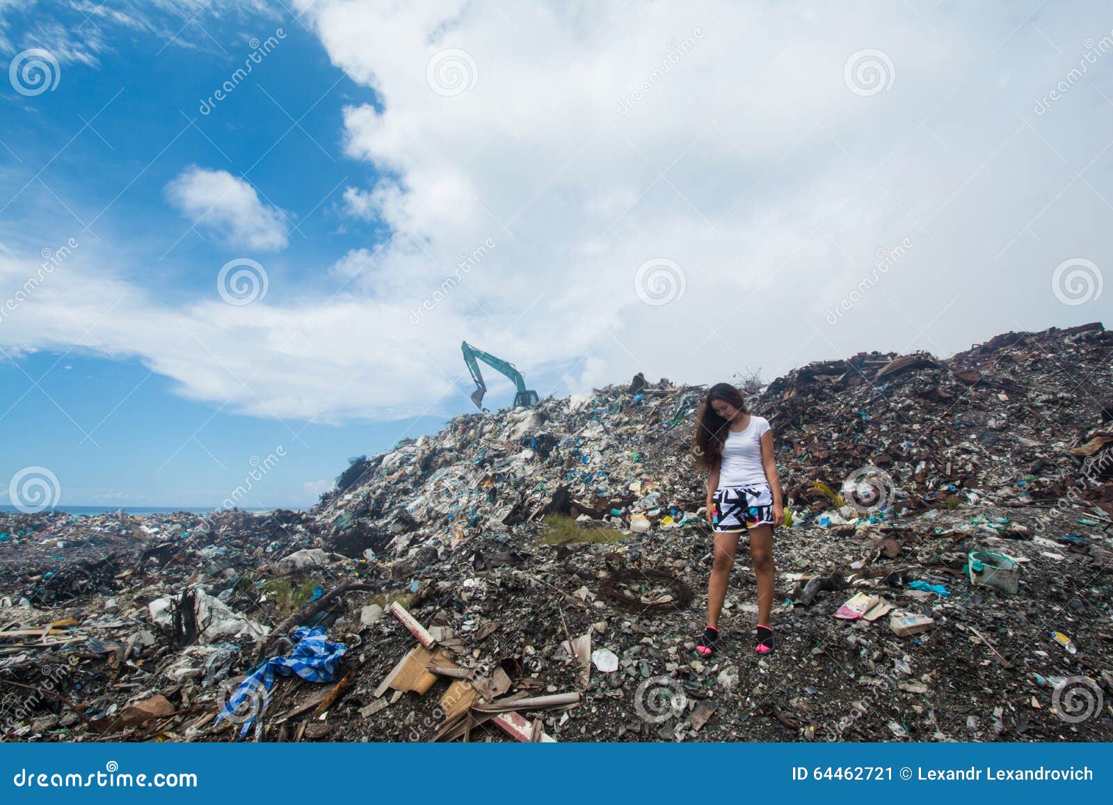 Girl Standing and Looking Sadly Down among Trash at Garbage Dump Stock ...