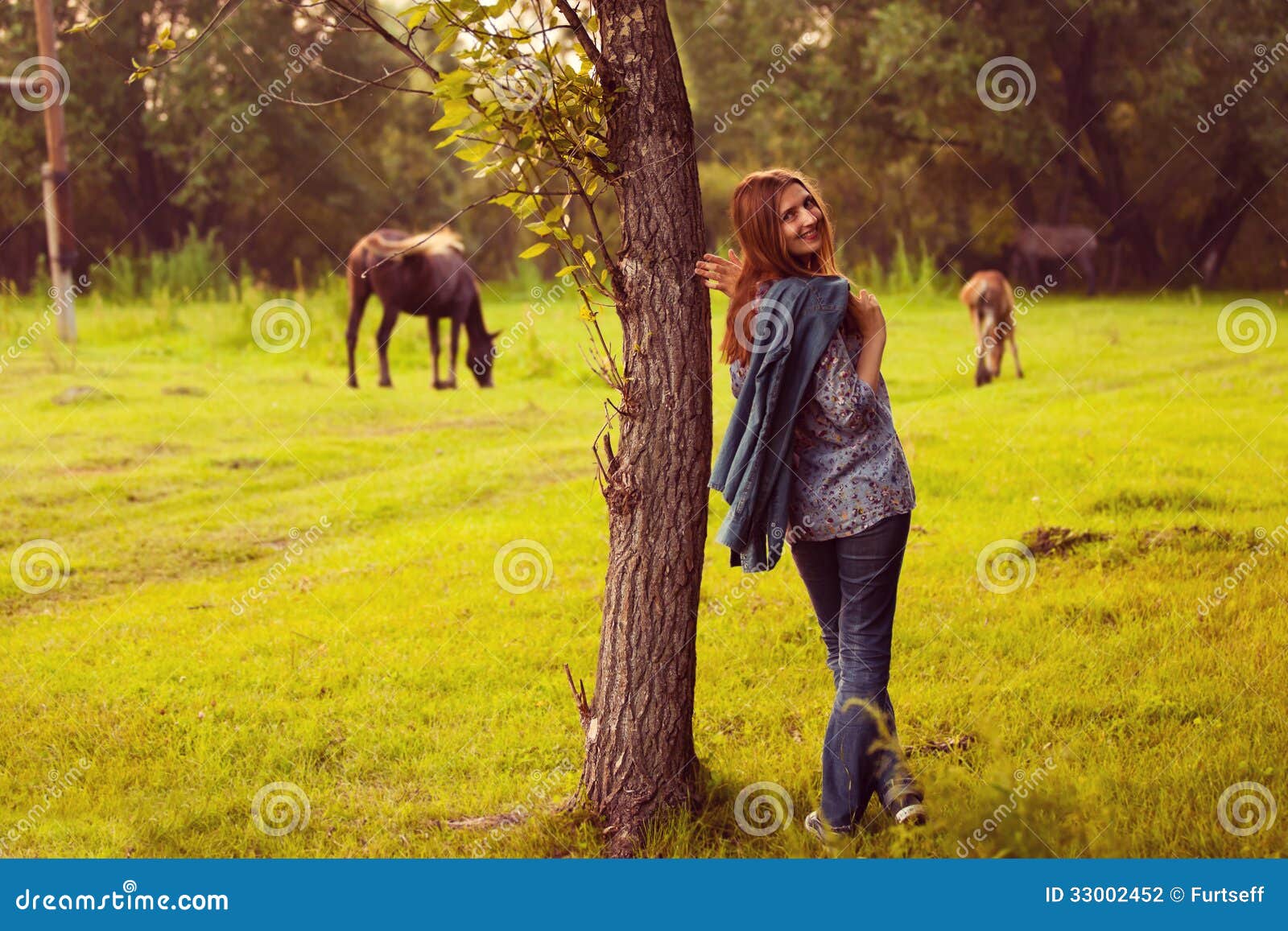Girl standing near a tree stock photo. Image of forest - 33002452