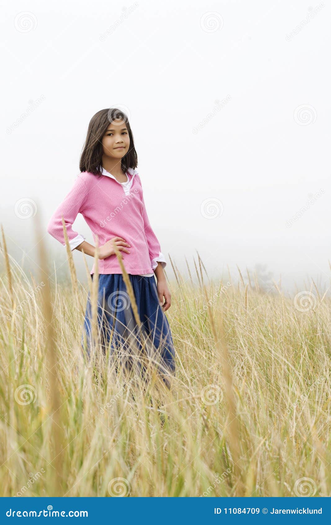 Girl Standing in Tall Grassy Field Stock Image - Image of serene ...