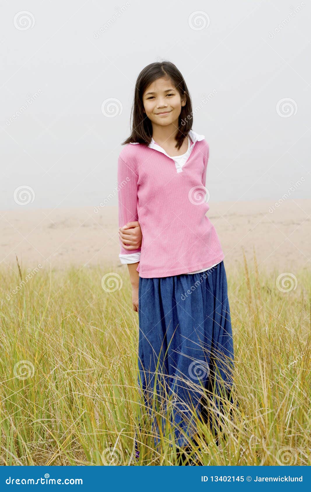 Girl Standing in Tall Grassy Field Stock Image - Image of misty, skirt ...