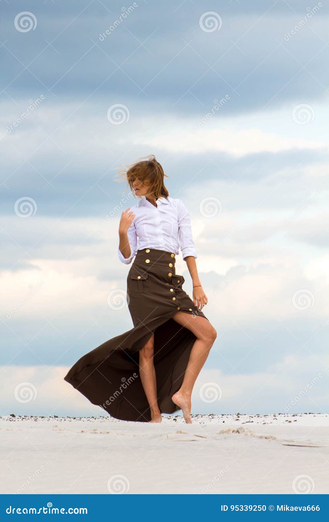 The Girl Stands in a Graceful Pose in the Wind Stock Photo - Image of ...