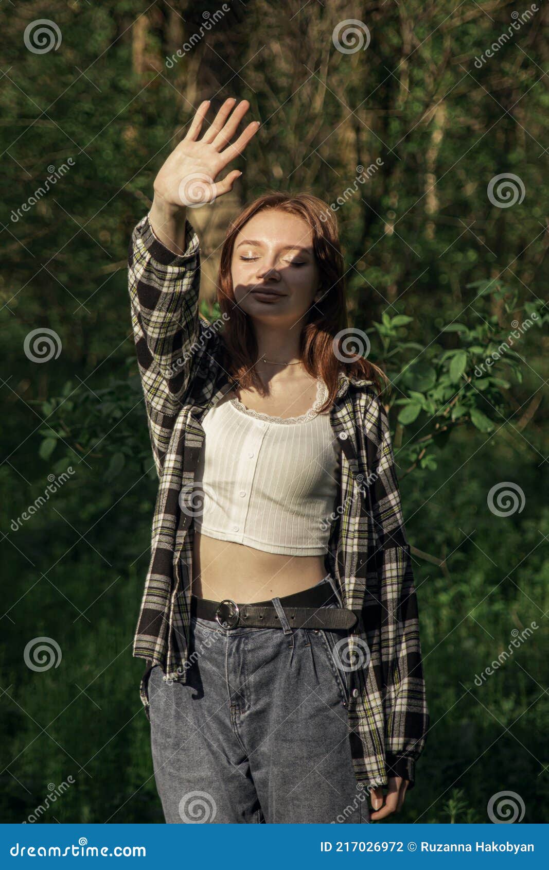 A Girl Stands Under The Rays Of The Sun In A Nature Photo The Girl Covers Herself With Her