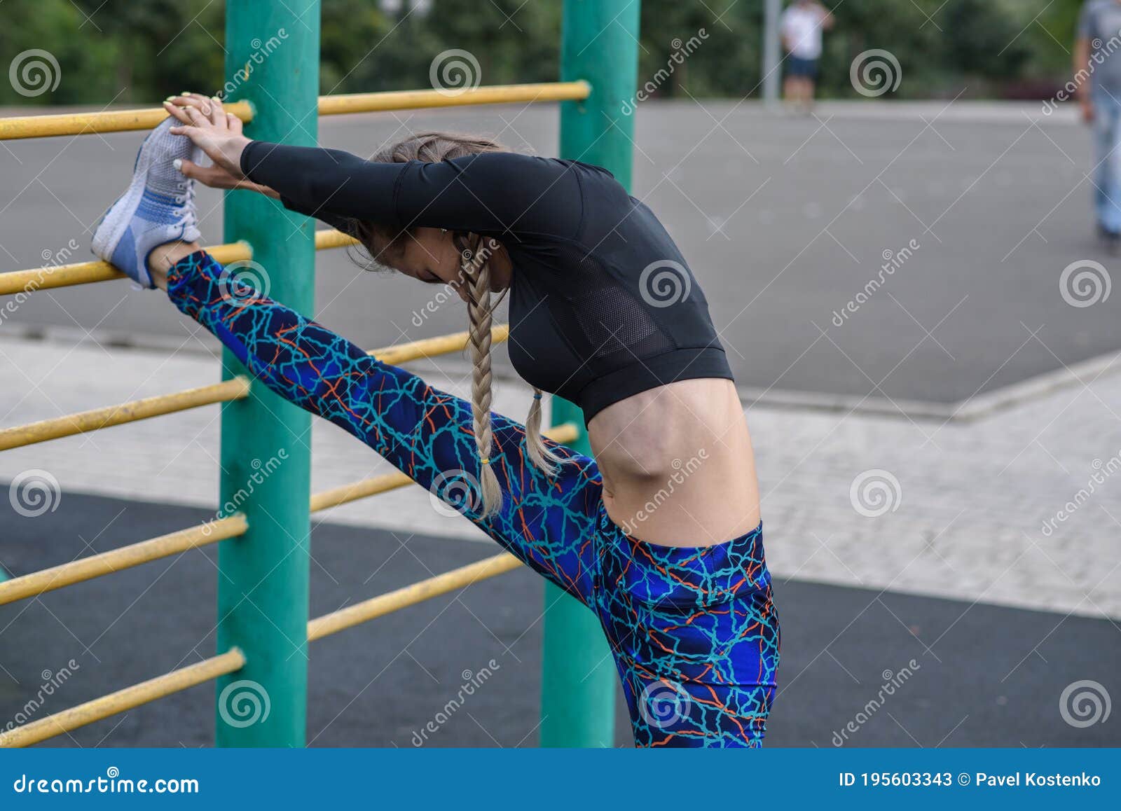 Girl Stretches on the Playground. Stock Image - Image of city, people ...