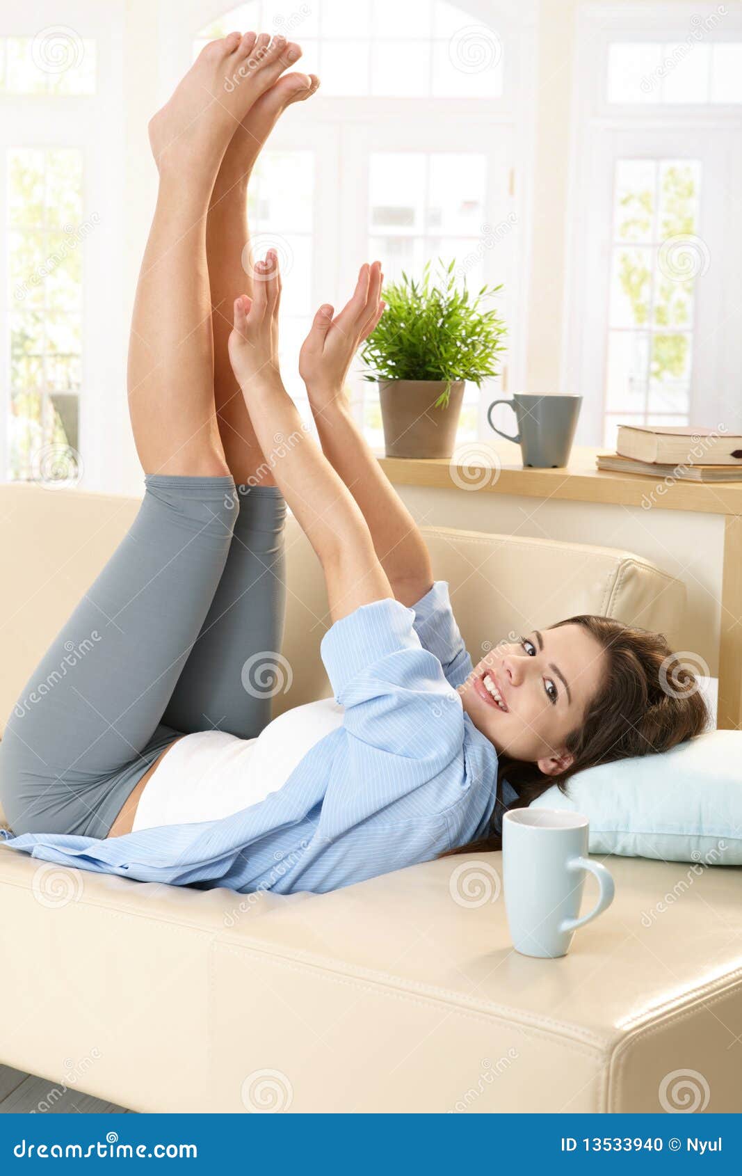 Girl stretching on couch stock photo. Image of holding - 13533940