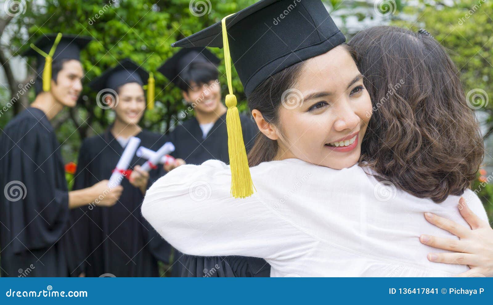 Girl Student with the Graduation Gowns and Hat Hug the Parent in ...