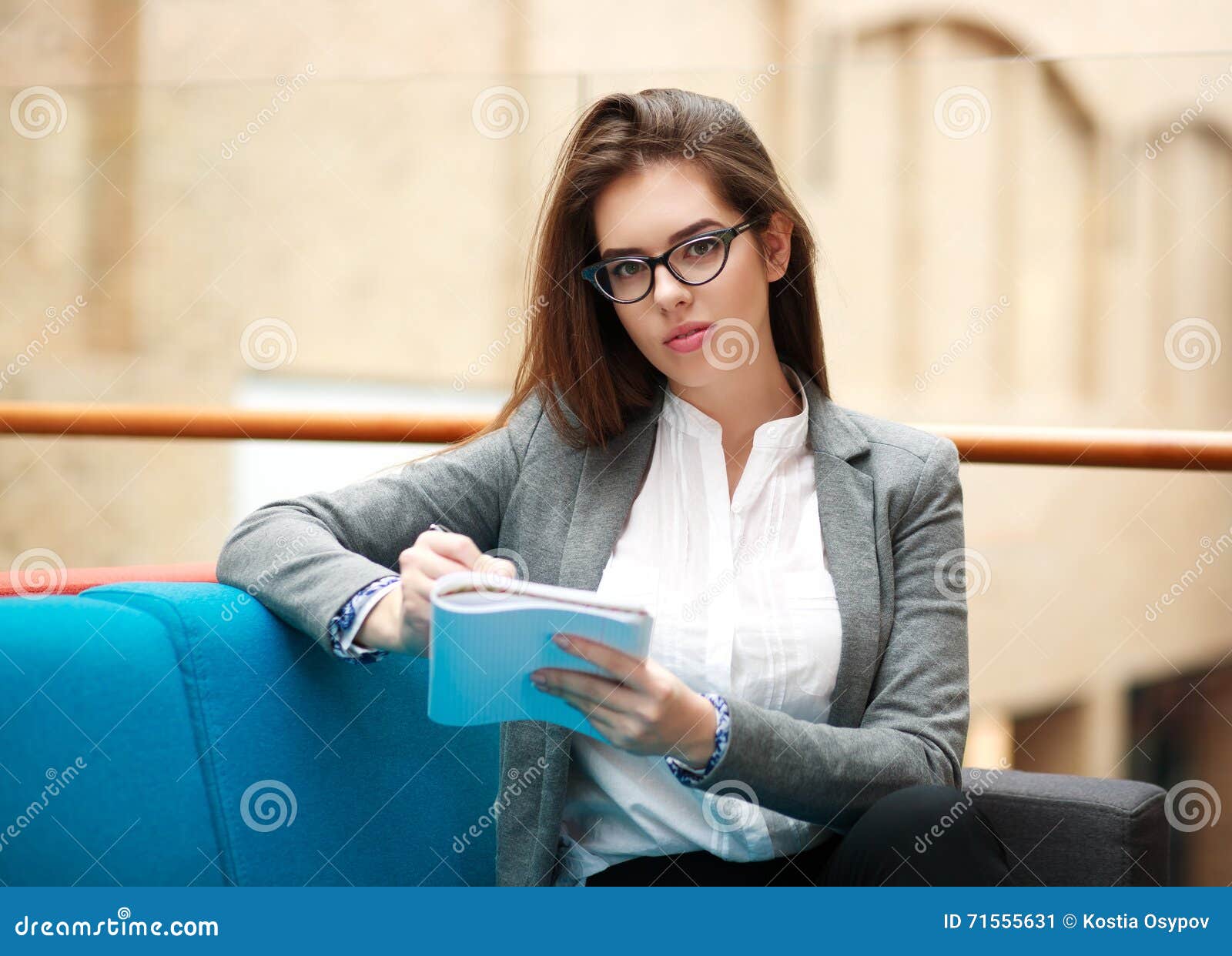 Girl Student Writing in Notebook Looking at Camera Stock Image - Image ...