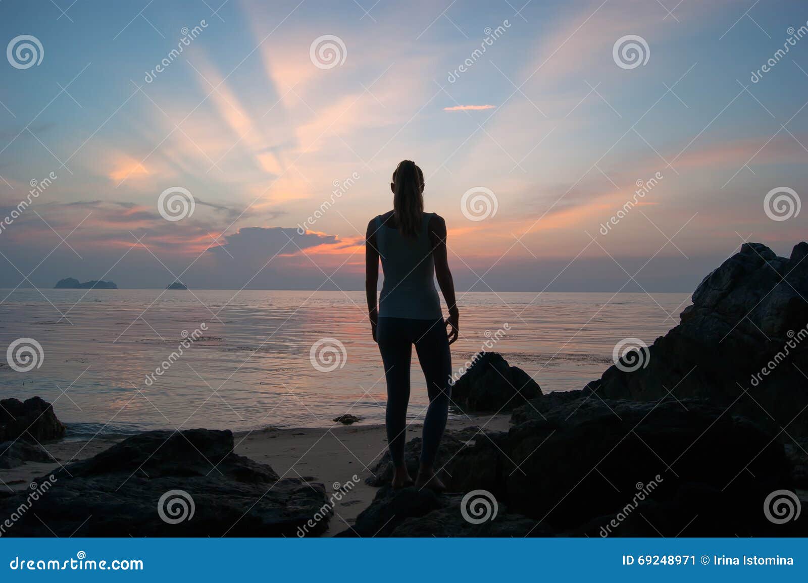 The Girl at Sunset Standing on the Seashore, the Colourful Sky. Stock ...