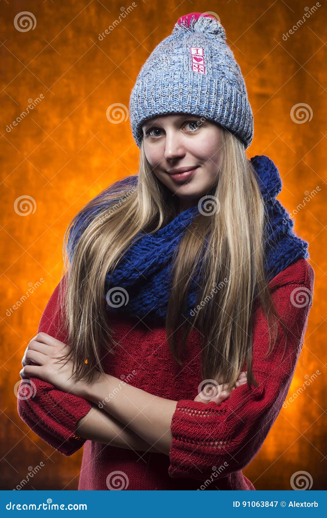 The Girl in a Sweater a Cap and a Scarf on an Orange Background Stock ...