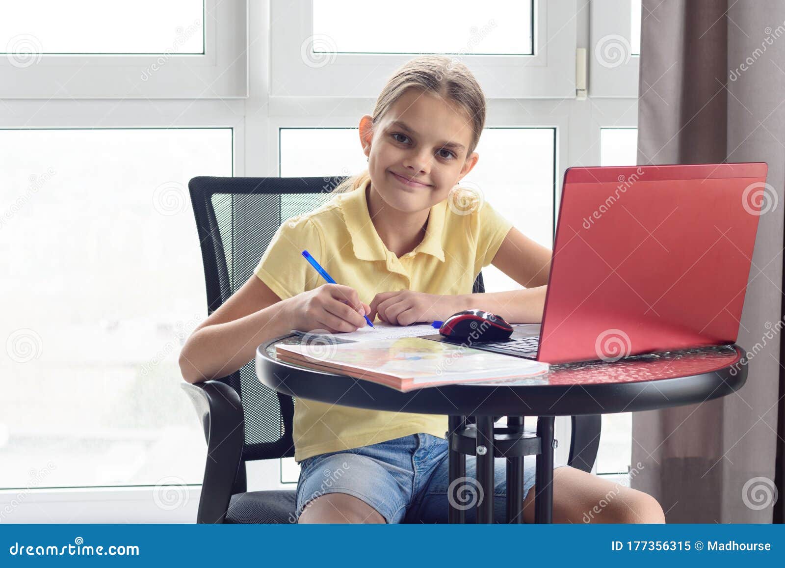 The Girl at the Table at Home Does Homework and Looked into the Frame ...