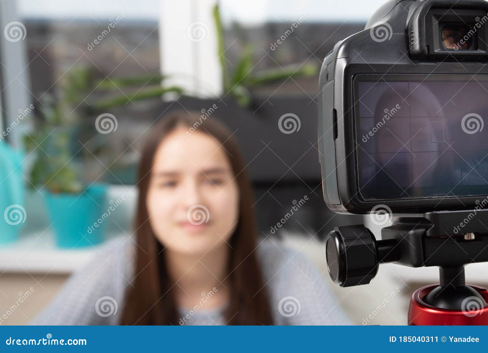 A Girl Takes a Video of Herself at Home in Front of a Camera Stock ...