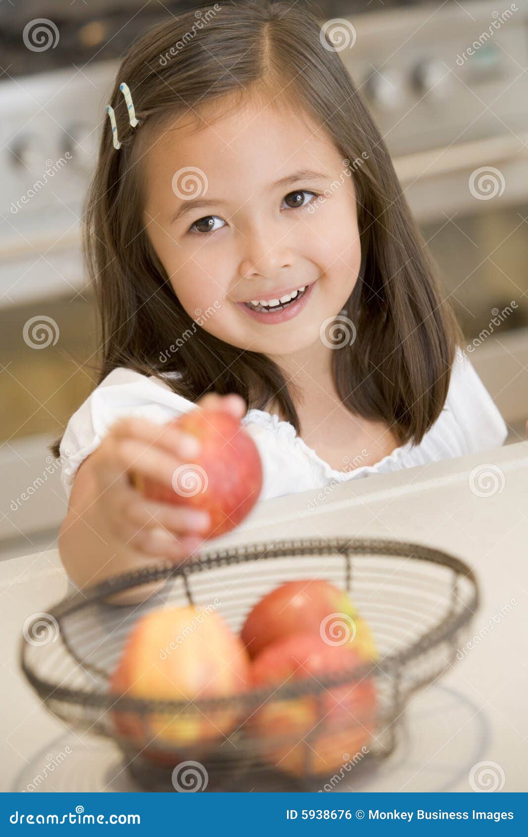 Girl Taking Apple from Fruit Basket at Home Stock Photo - Image of head ...