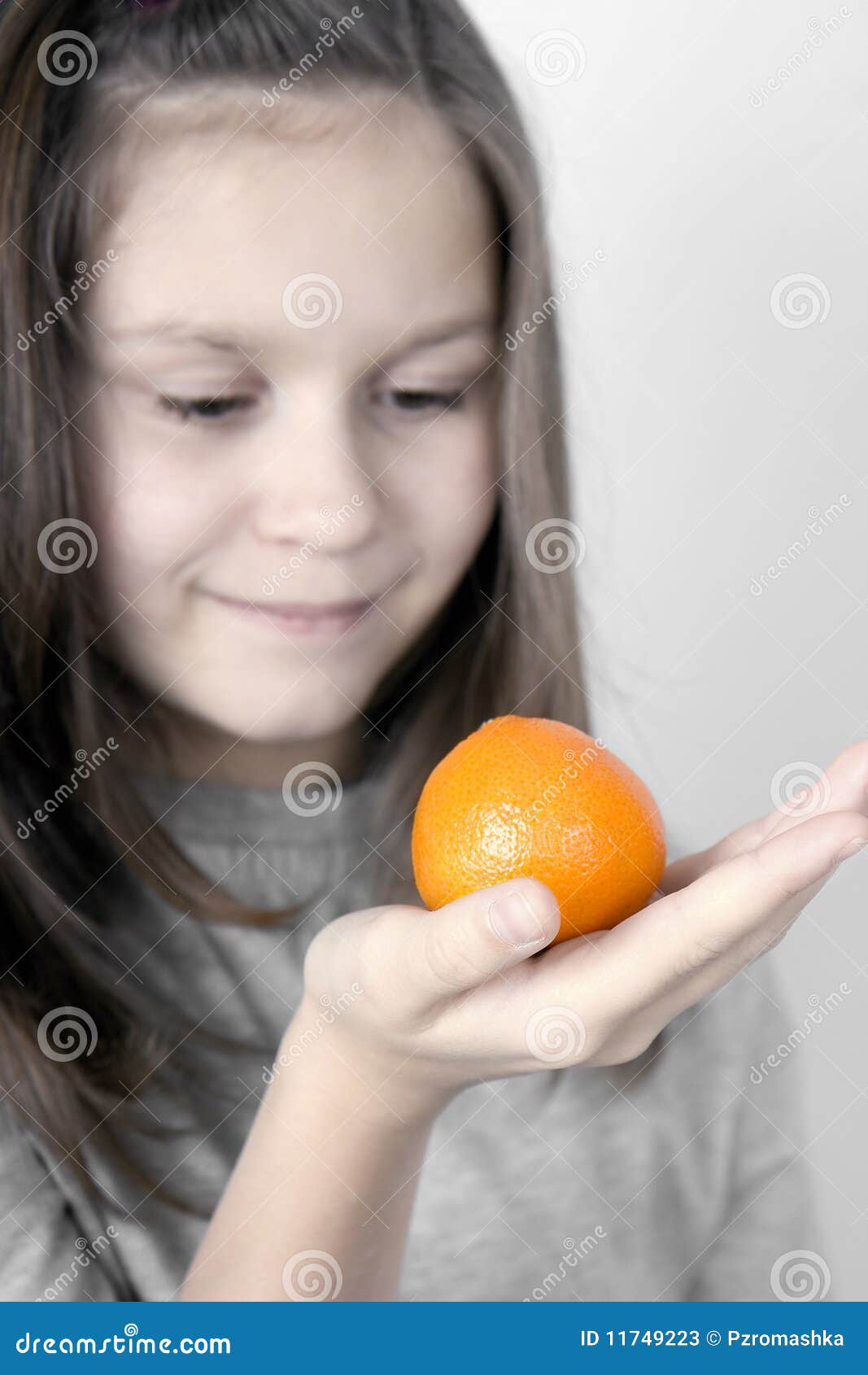 The girl and a tangerine stock image. Image of harmony - 11749223