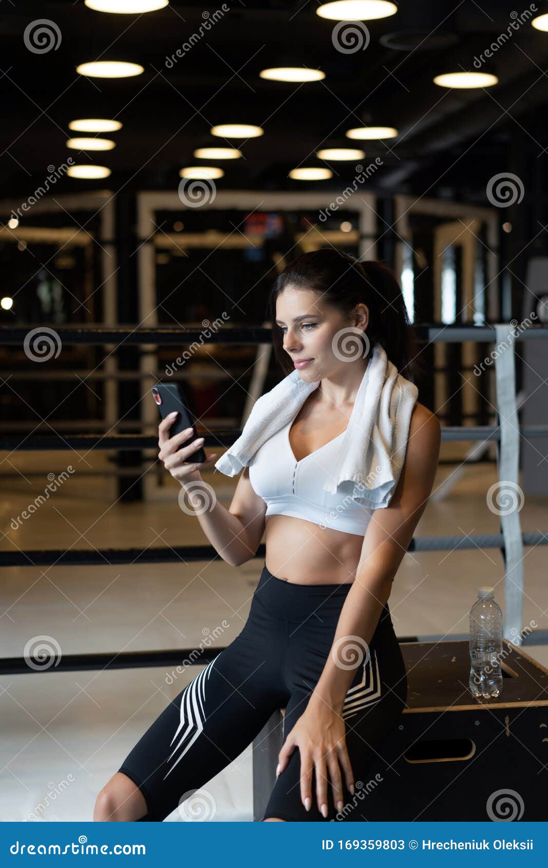 Girl Texting while Taking a Break in a Gym. Reads a Message Stock Image ...