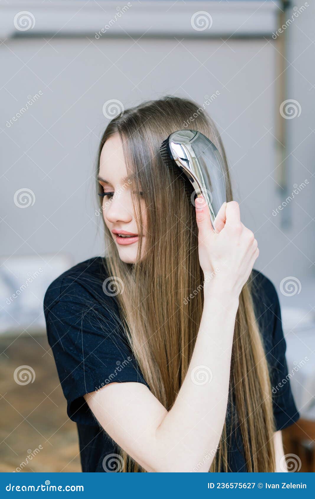 Girl Touching Her Hair And Smiling While Posing At Interior Looking In