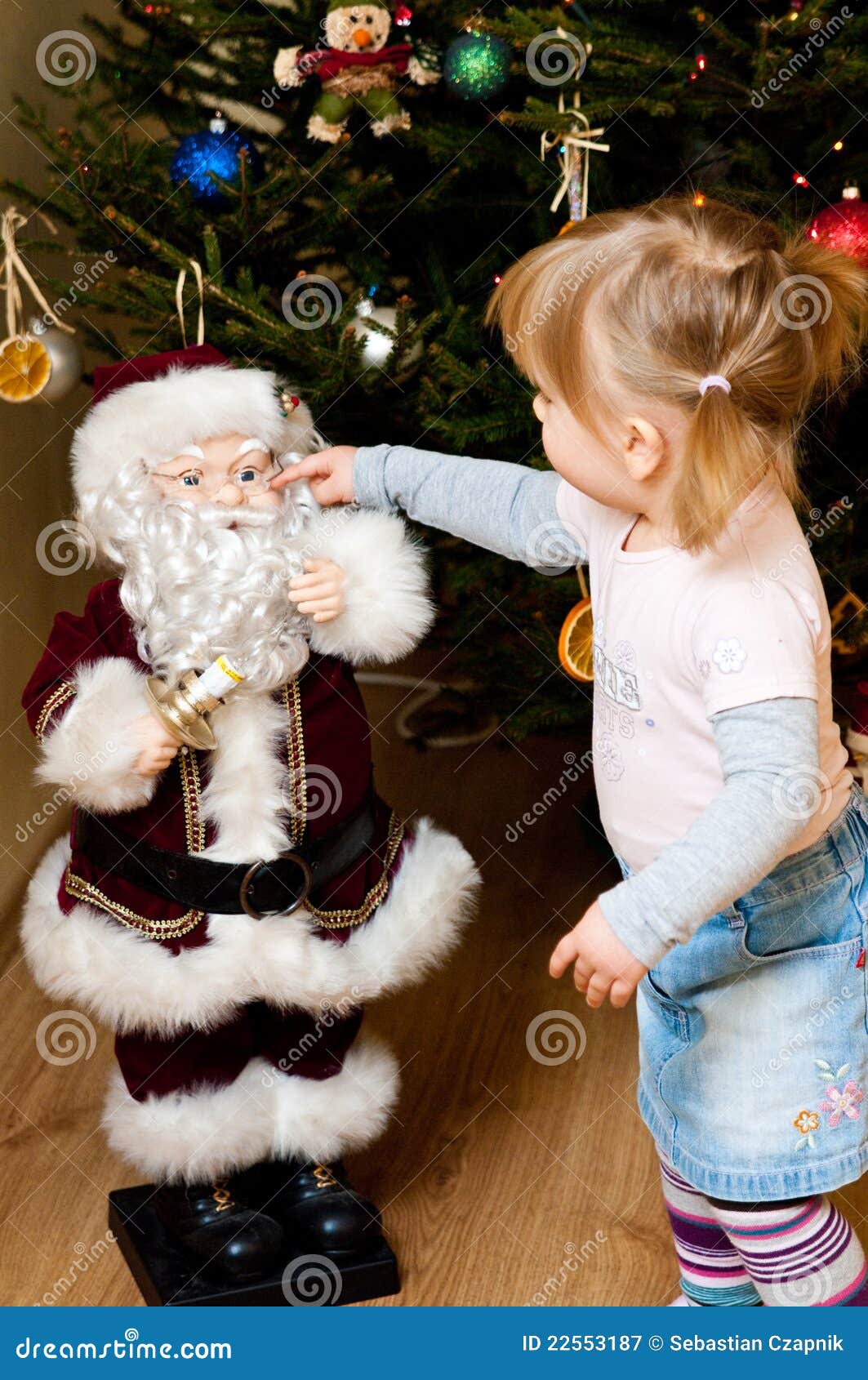 Girl touching Santa Claus stock image. Image of female - 22553187