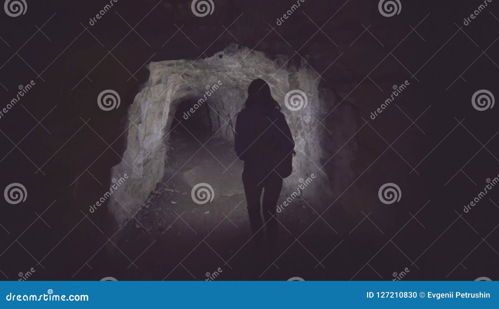 Girl Tourist is a Cave with a Flashlight from Behind Stock Photo ...