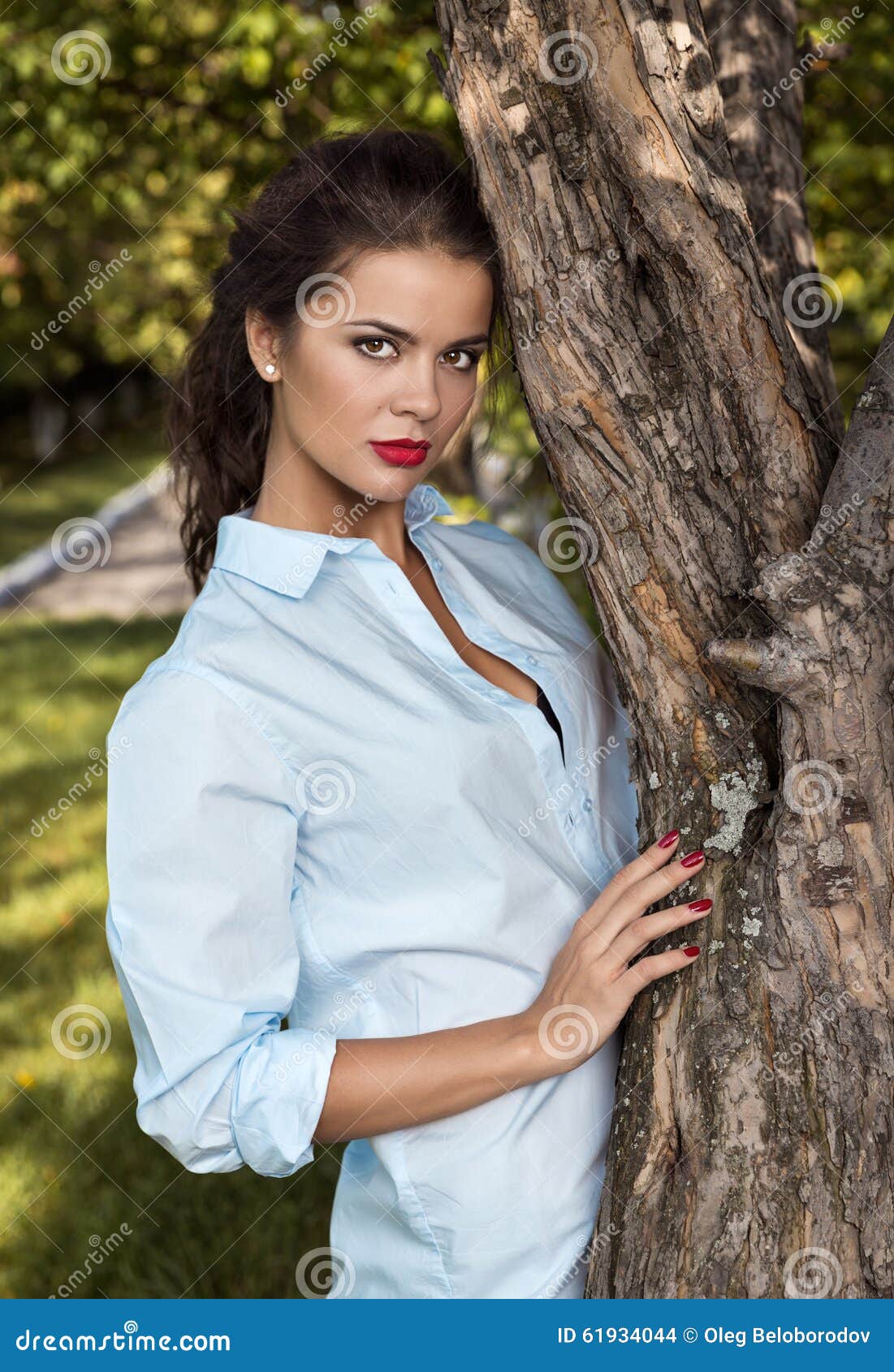 Girl at a tree trunk stock photo. Image of thoughtful - 61934044