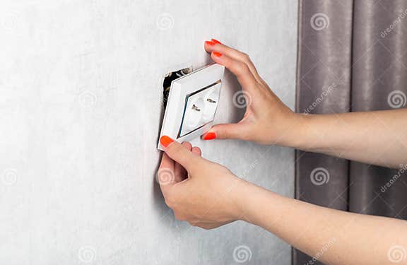 The Girl is Trying To Insert a Torn Out Socket from the Socket Due To ...