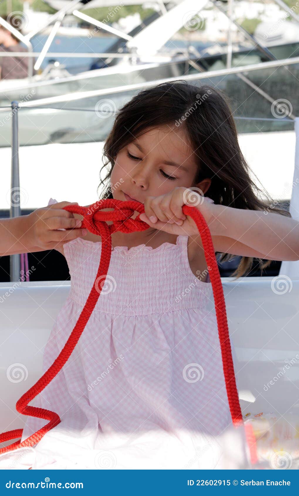 Girl tying knot in rope stock image. Image of hands, rope - 22602915